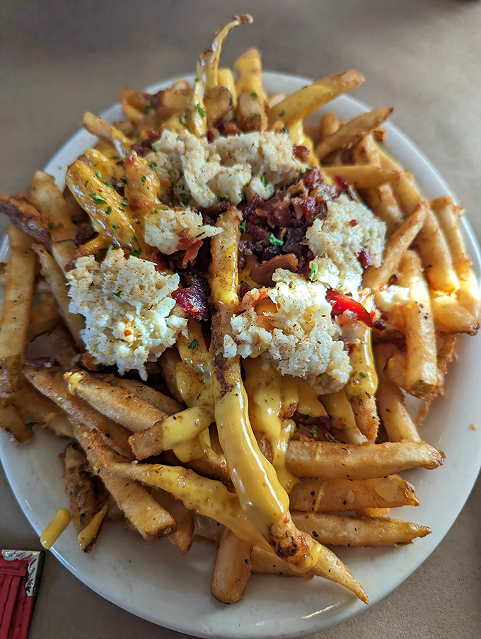 Crab-topped fries: where boardwalk comfort food meets maritime luxury. The cheese sauce river flowing through this potato mountain is pure genius.