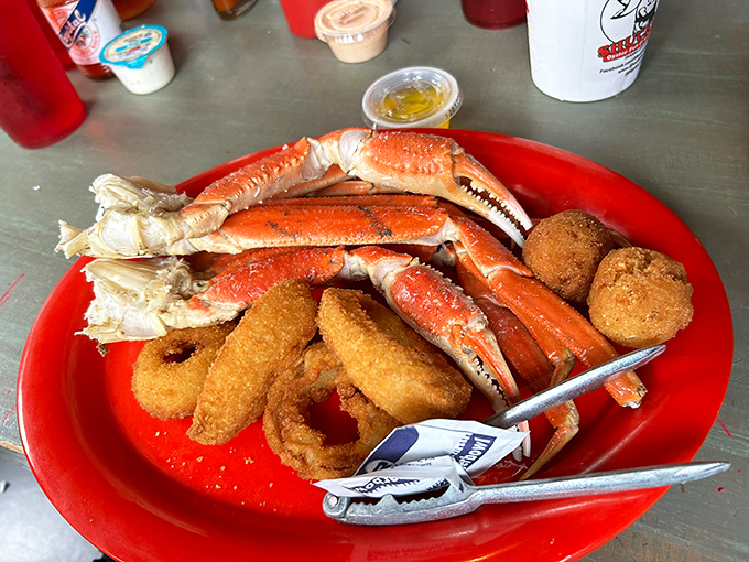 Snow crab legs and onion rings sharing a plate like the odd couple of seafood. Those crackers aren't just tools&mdash;they're the keys to unlocking oceanic treasure.