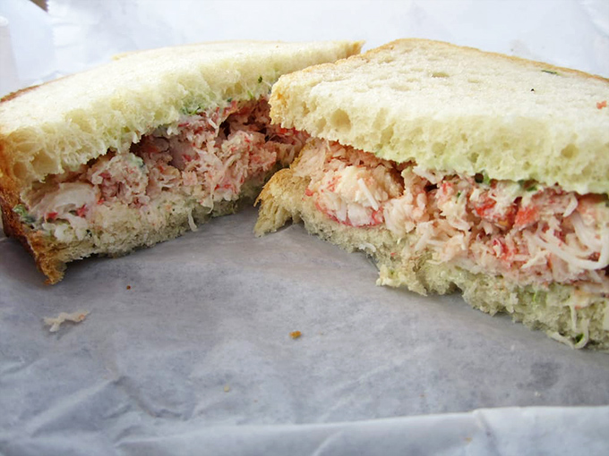 Cross-section perfection: the crab sandwich reveals its generous filling. Like peeking inside a treasure chest, except you can eat this bounty.