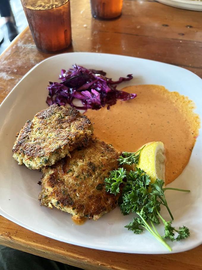 Golden-brown crab cakes that could make a Marylander nod in approval, served with a sauce that demands to be scraped clean from the plate.