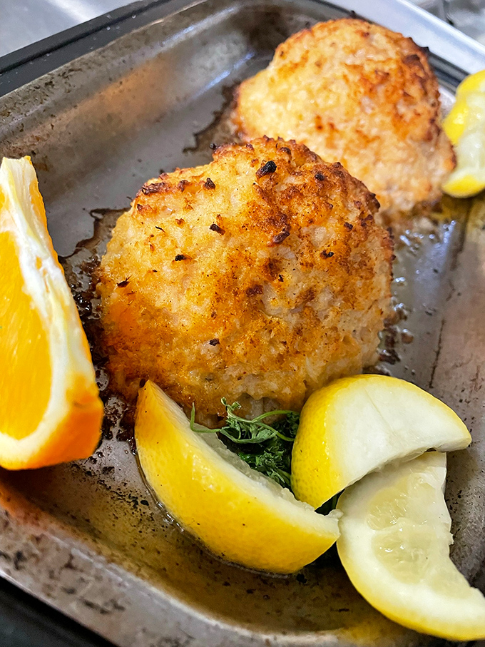 The legendary crab cakes that launched a thousand road trips. Golden-brown perfection with just enough seasoning to let the sweet crab shine through.