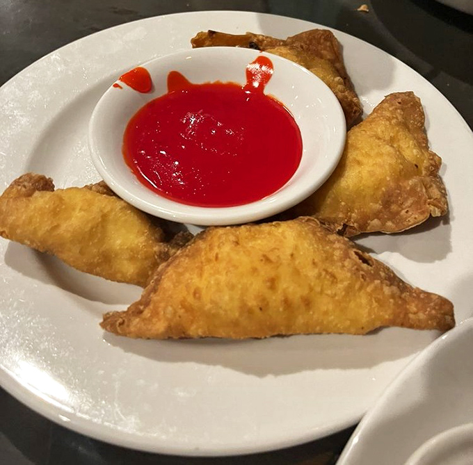 Golden crabmeat rangoon arrives like little pillows of happiness, crispy outside and creamy within.