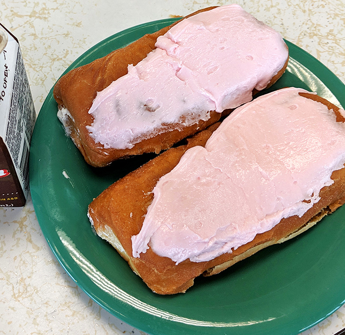 Pretty in pink and ready for their close-up. These cream-filled long johns don't just satisfy hunger &ndash; they're the dessert equivalent of a warm hug from your favorite aunt.