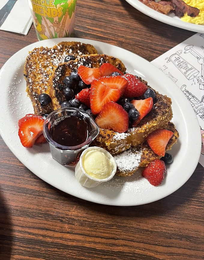 French toast that's had a proper introduction to fresh berries, maple syrup, and powdered sugar &ndash; a breakfast love triangle that works.