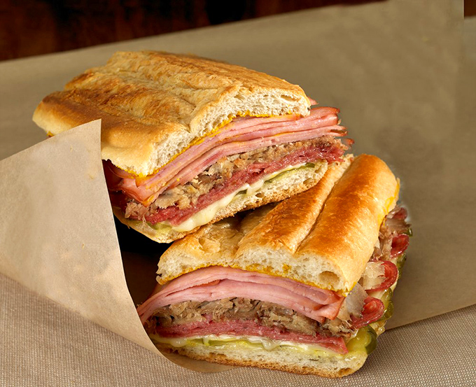 The Cuban sandwich—architectural perfection between bread. Layers of ham, roast pork, and cheese pressed into what might be Florida's most perfect handheld meal.