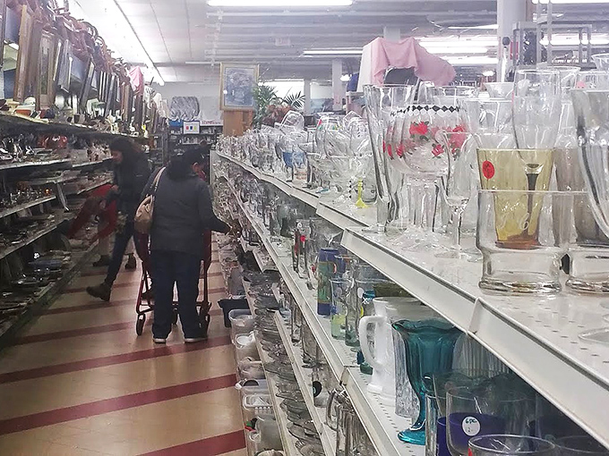 Two happy hunters emerge victorious with vintage lamps that probably witnessed the moon landing firsthand.