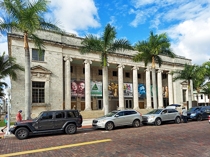 The stately Sidney & Berne Davis Art Center stands as a cultural cornerstone, its classical columns offering a dignified contrast to the swaying palms nearby.