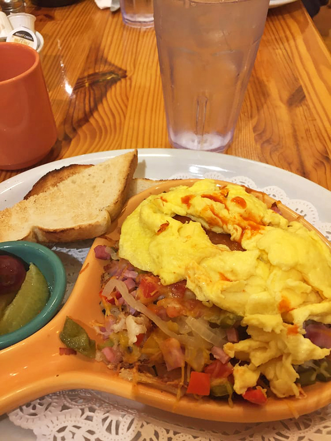 Behold the skillet in all its glory – a colorful landscape of vegetables and eggs that makes ordinary omelets look like they're not even trying.