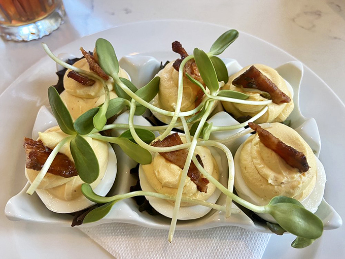 These aren't your church picnic deviled eggs. Topped with candied bacon and microgreens, they're the country cousin who went to culinary school.