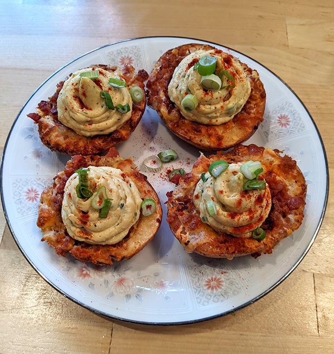 These aren't your average potato skins. Crispy vessels topped with creamy, spiced filling and fresh scallions&mdash;comfort food that got a graduate degree.