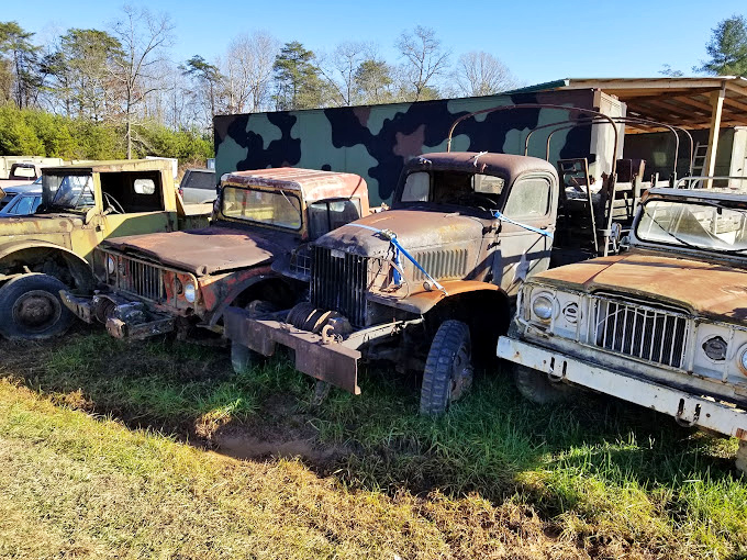 Vintage military trucks stand guard like mechanical sentinels. These restored Dodge Power Wagons have stories that would make your Jeep blush.