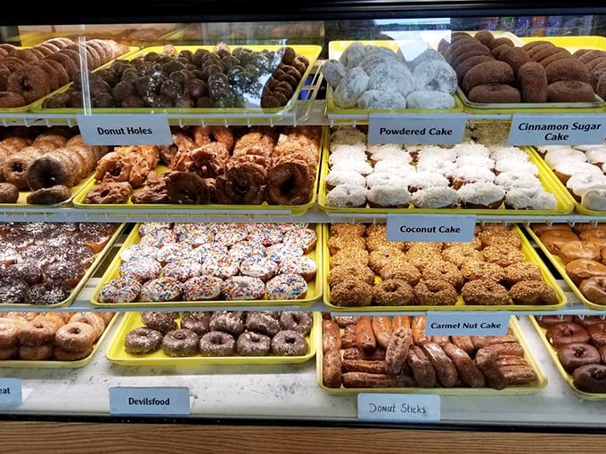 Donut heaven exists, and it's organized in neat yellow trays. Each variety patiently waits its turn to change someone's day.