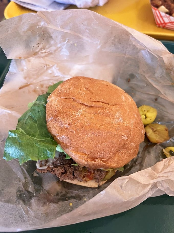 Simplicity on a bun. The humble burger in its natural habitat, nestled on wax paper &ndash; no pretension, just pure flavor awaiting discovery.