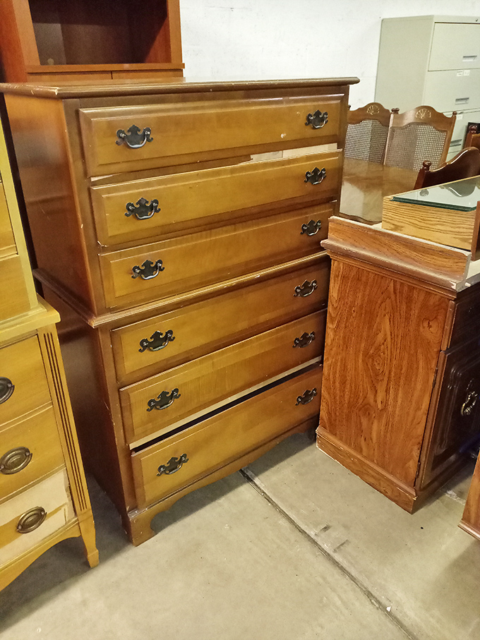 Behold, the dresser of dreams! Those brass handles have been pulled by countless hands, each drawer potentially hiding someone's forgotten treasures.