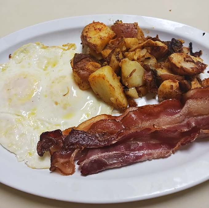 The holy trinity of breakfast: perfectly cooked eggs, crispy bacon, and hash browns that actually taste like potatoes.