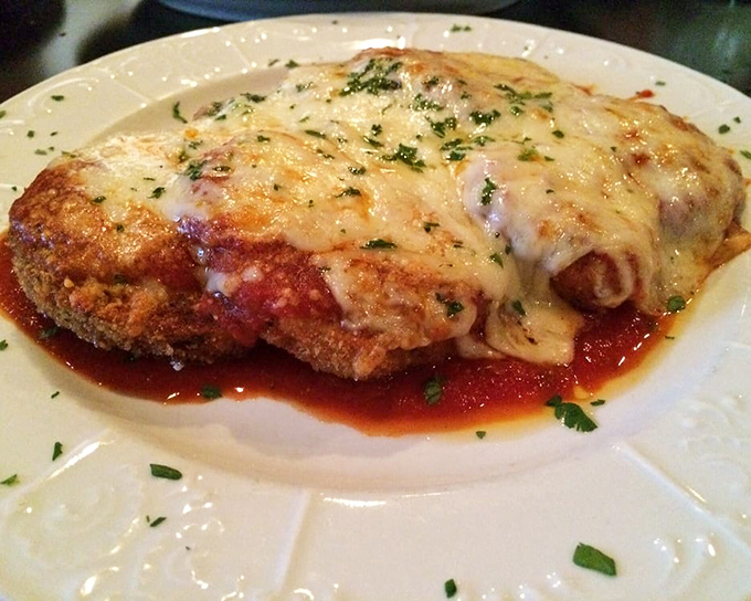 This eggplant parmigiana doesn't just melt in your mouth &ndash; it stages a full-scale flavor invasion that'll have you plotting your next visit before the plate's empty. 