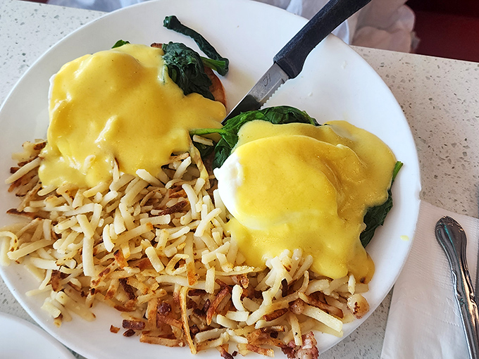 Eggs Benedict that defies gravity—that hollandaise sauce is sunshine on a plate, paired with perfectly crispy hash browns.
