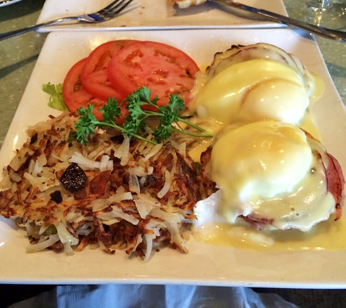 Eggs Benedict done right: golden hollandaise cascading over perfectly poached eggs, with hash browns crisped to perfection. Breakfast nirvana has been achieved.