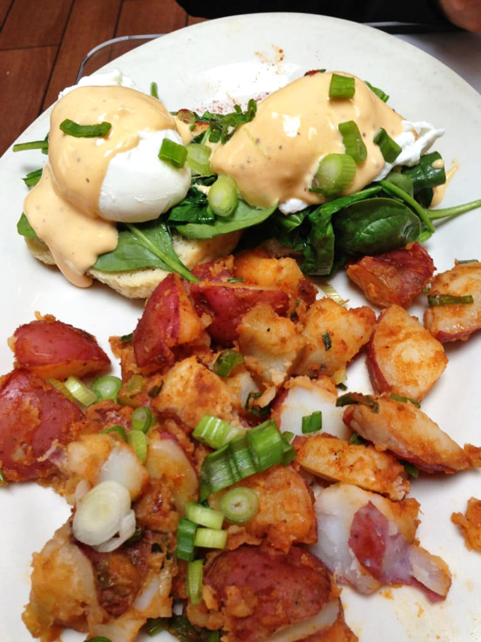 Eggs Benedict gets the Creole treatment with perfectly poached eggs, vibrant greens, and a hollandaise sauce you'll want to bottle and take home.