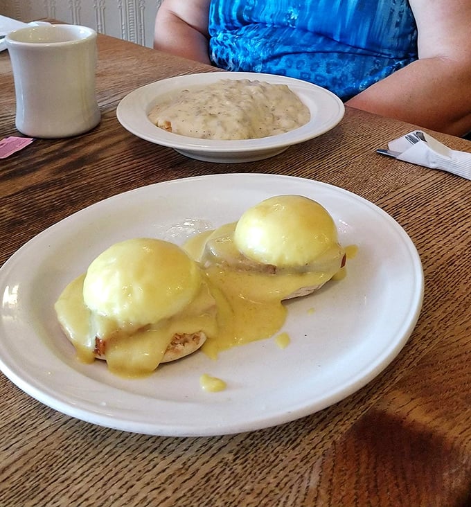 Eggs Benedict done right: perfectly poached eggs, silky hollandaise, and a side of gravy-smothered biscuits that would make your grandmother jealous.