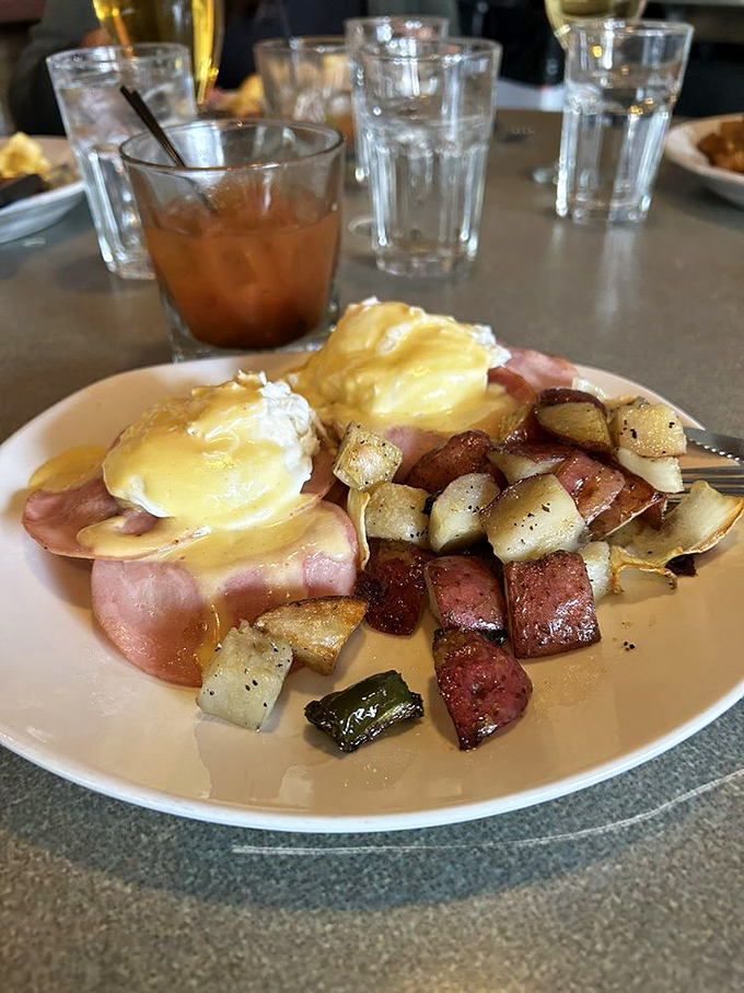 Eggs Benedict: where breakfast meets art. Canadian bacon cradles those perfectly poached eggs like they're precious jewels.