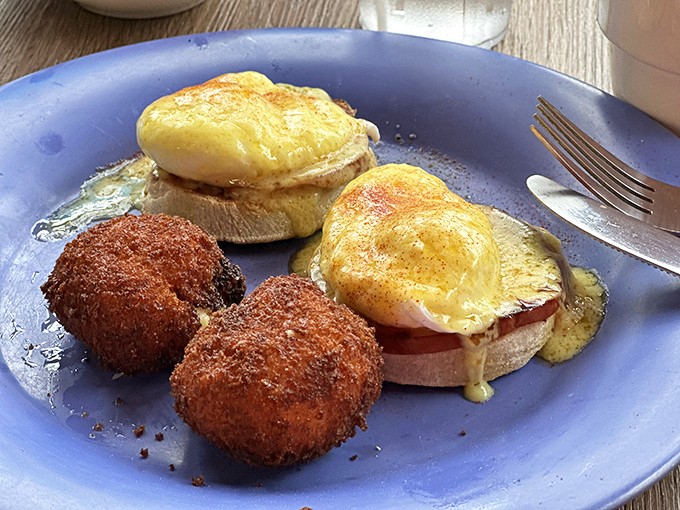 Eggs Benedict with a side of potato croquettes—proof that breakfast can be both elegant and satisfying without requiring a second mortgage.