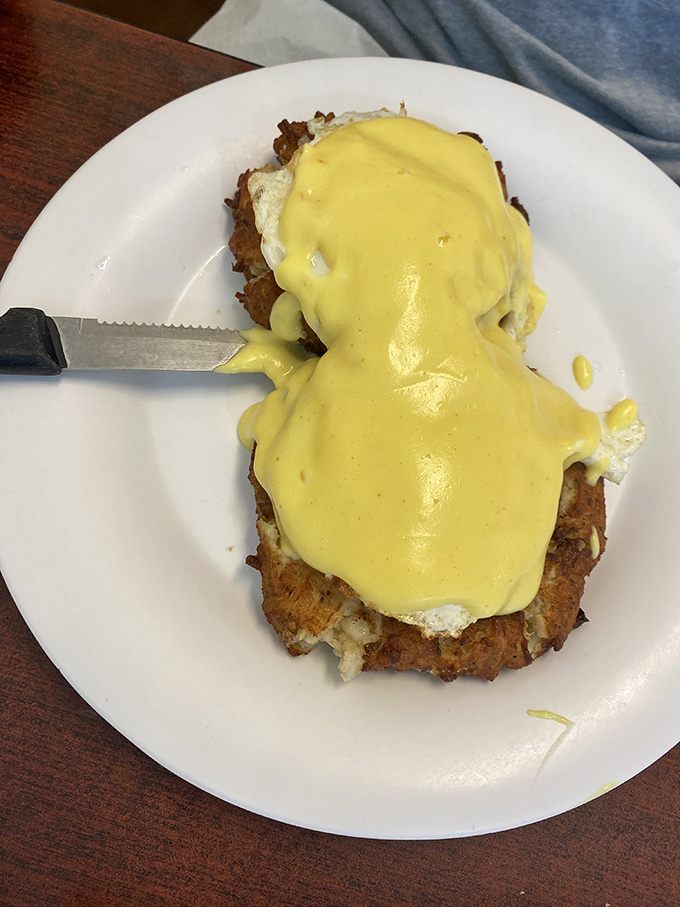 Eggs Benedict done right: a golden hollandaise cascade that would make Julia Child slow-clap in approval.