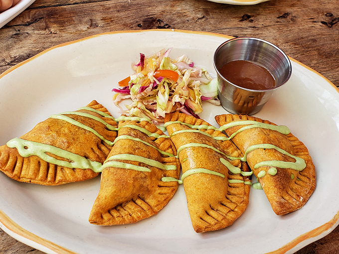 Golden empanadas with a drizzle of green sauce that says, "Yes, we're pretty, but we mean business." Crispy on the outside, heaven on the inside.