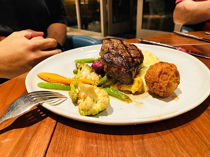 Filet medallions cooked to blushing perfection, proving land and sea can coexist deliciously on one menu.