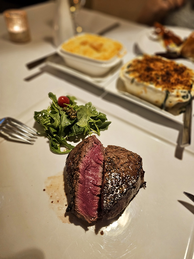 The filet mignon at Ernie's reveals its blushing interior like a culinary love letter, accompanied by sides that know their supporting role.