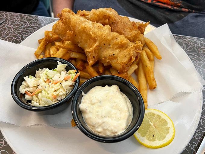 Golden-battered fish that shatters with each bite, served with fries so perfectly crisp they deserve their own fan club.