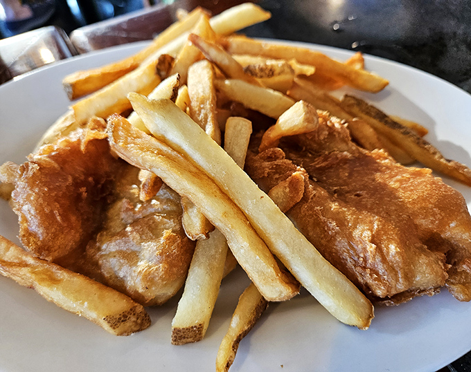 Fish and chips done right&mdash;crispy, golden batter protecting flaky white fish. The kind of comfort food that makes you want to hug the chef.