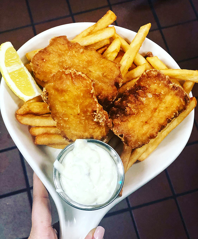 Golden-battered fish and chips that would make coastal towns jealous, served with a side of tartar sauce for dunking.