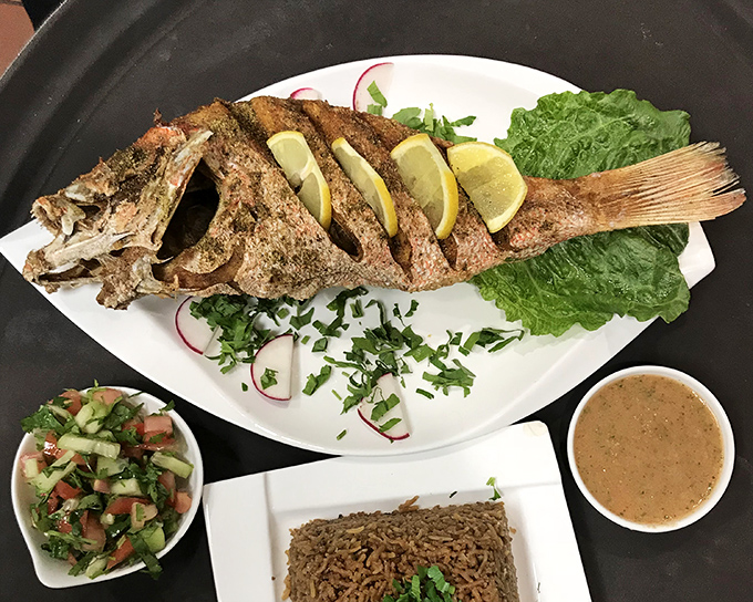 When a whole fish arrives at your table looking this good, you know you're in for something special. The crispy exterior gives way to tender, flavorful flesh.
