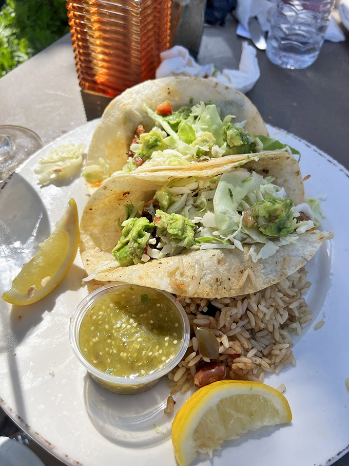 Fish tacos that make you question why you ever eat anything else. That green sauce isn't just condiment&mdash;it's liquid sunshine in a cup.