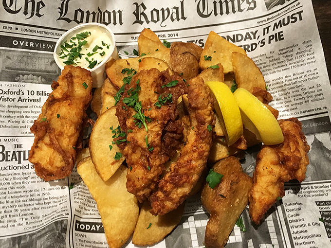 Fish and chips served on newspaper &ndash; a crispy, golden tribute to Britain's greatest culinary export, minus the London drizzle and seagulls.