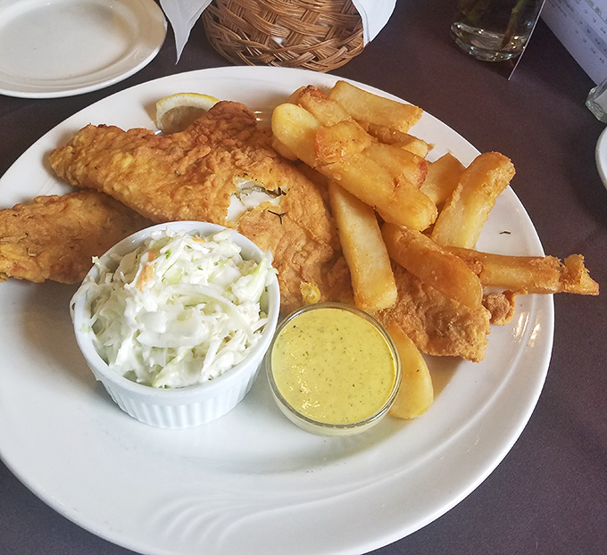 Golden-battered fish alongside crispy fries and house-made slaw &ndash; the kind of plate that makes you forget your table manners.