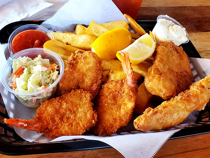 Golden-battered fish and chips sit alongside, coleslaw, and a wedge of lemon&mdash;a seafood platter worthy of making Neptune trade his trident for a fork.