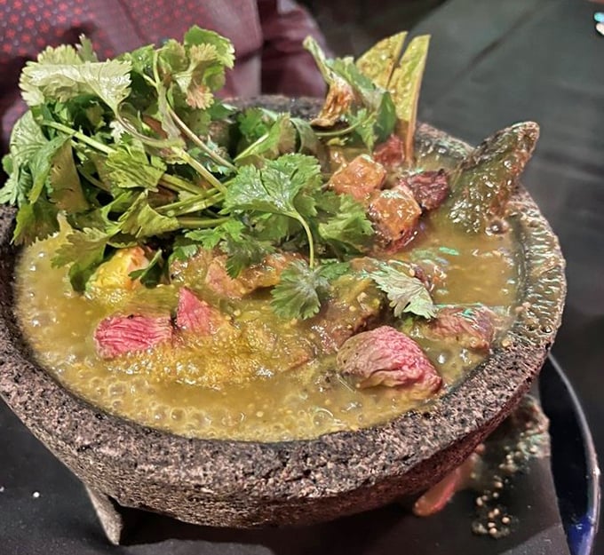 The molcajete isn't just a dish, it's a volcanic rock concert of flavors where cilantro plays lead guitar over perfectly cooked steak.