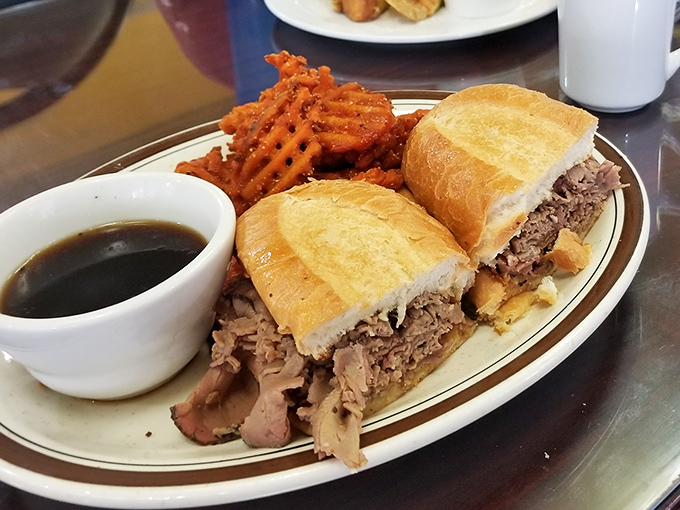 A French dip that would make Parisians jealous, served with waffle fries that somehow maintain their architectural integrity despite being absolutely irresistible.