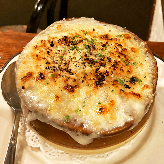 This isn't just French onion soup; it's a bubbling cauldron of cheese-capped bliss that demands a moment of reverential silence before diving in.