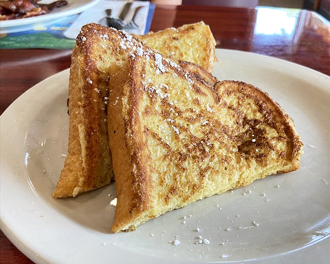 The legendary French toast that launched a thousand road trips. Golden, crispy edges giving way to custardy perfection.