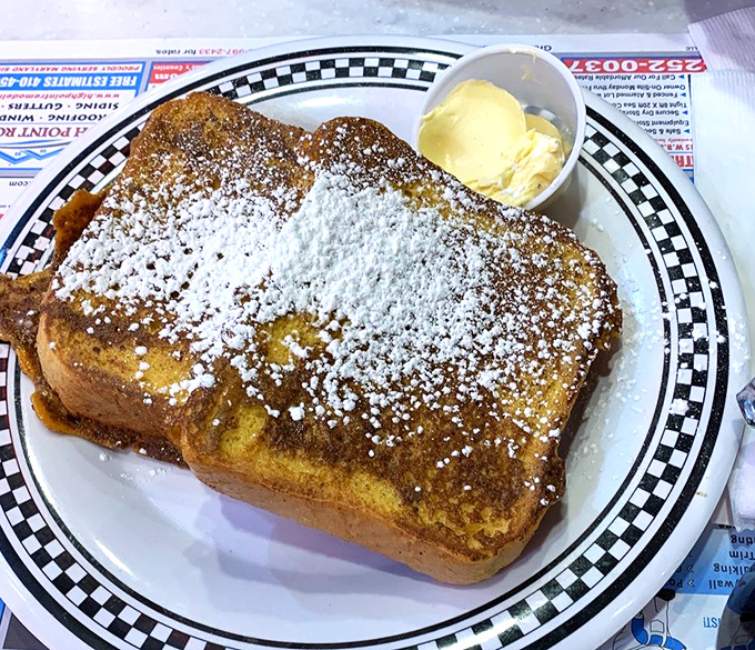 This French toast doesn't just arrive&mdash;it makes an entrance, dusted with powdered sugar like fresh snow on a delicious landscape.