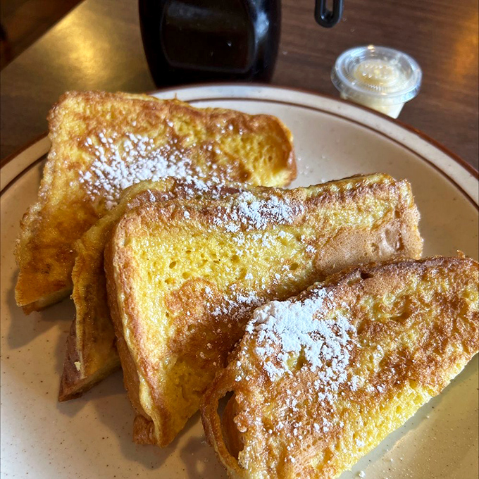 Golden-edged French toast dusted with powdered sugar&mdash;proof that simplicity, when done right, outshines even the fanciest brunch concoctions in town.