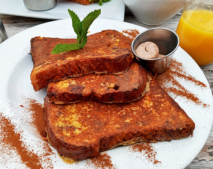 French toast that's been dipped, griddled, and dusted with such care it makes you wonder if it attended finishing school. That cinnamon butter is the crown jewel.
