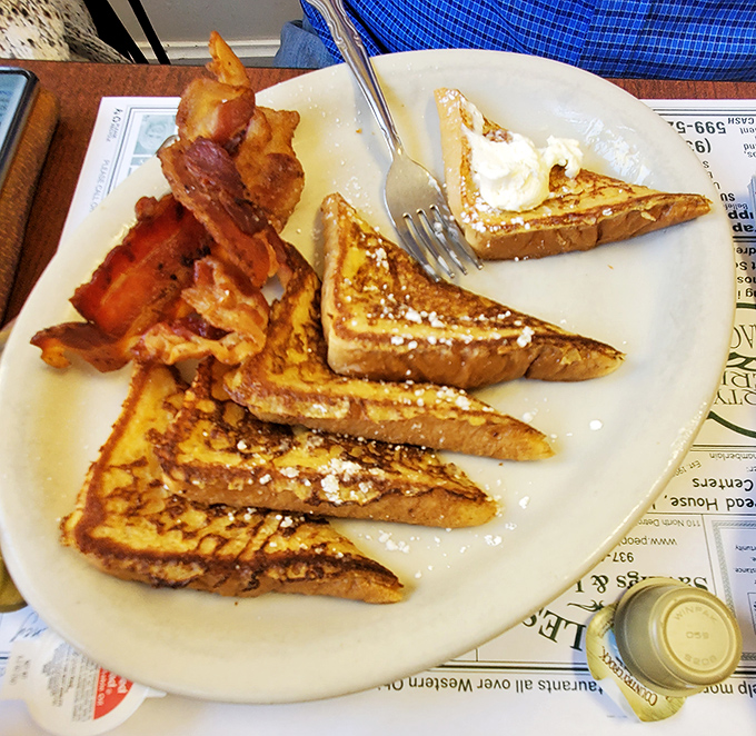 French toast that doesn't need a passport to impress, served with bacon that's achieved that magical balance between crisp and chewy.