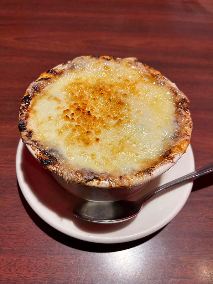 French onion soup that's wearing its cheese crown with pride. Breaking through that golden crust feels like discovering buried treasure.