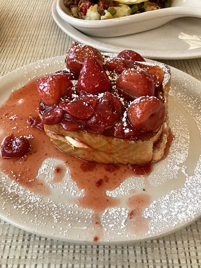 This strawberry-topped French toast isn't just breakfast, it's an edible love poem to morning indulgence. The powdered sugar is just showing off.