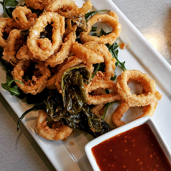 Crispy calamari that shatters with each bite, paired with a sauce that makes you wonder why you ever settled for marinara. This is squid's highest calling.