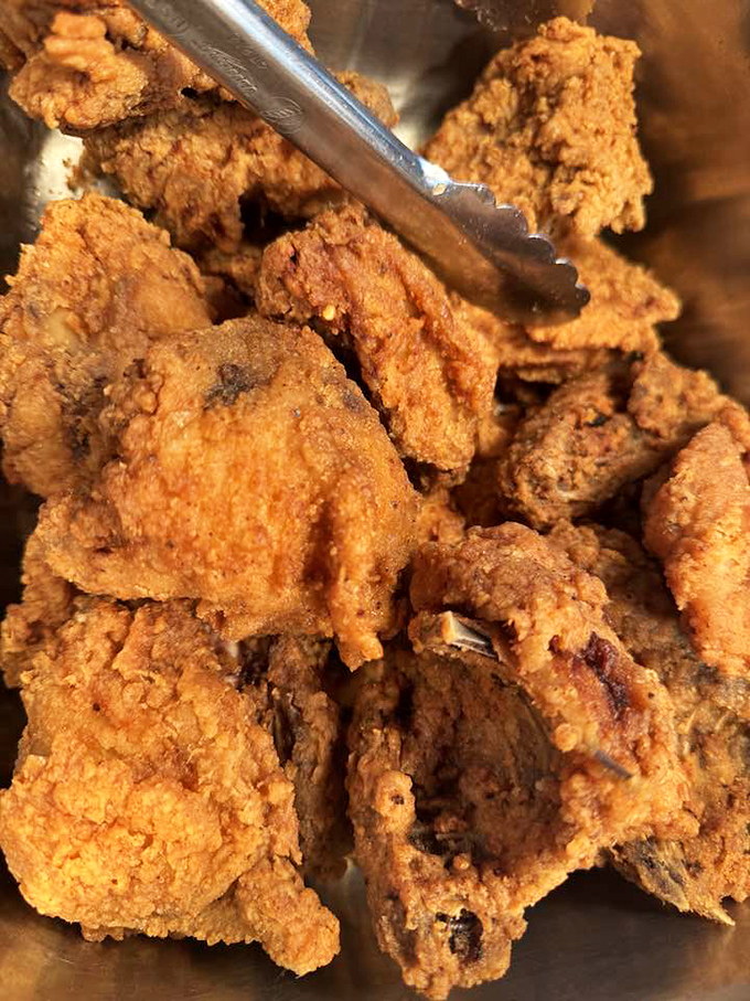 Fried chicken so perfectly golden it deserves its own trophy. That crackling crust is the sound track to happiness in the South.